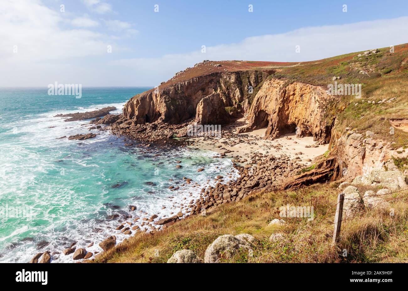 Rocky beach with caves in Mill Bay, Cornwall, England Stock Photo - Alamy