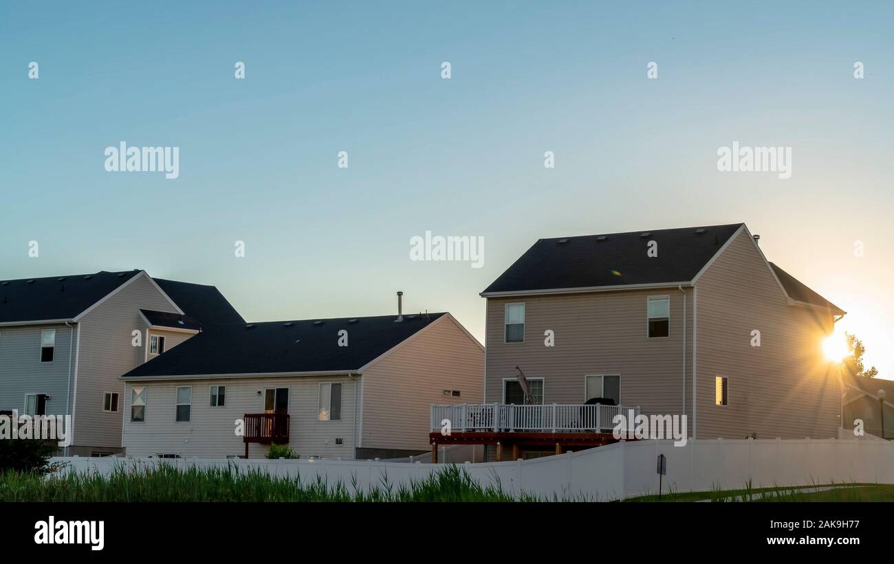 Pano frame Exterior view of lovely homes with bright sun and blue sky ...
