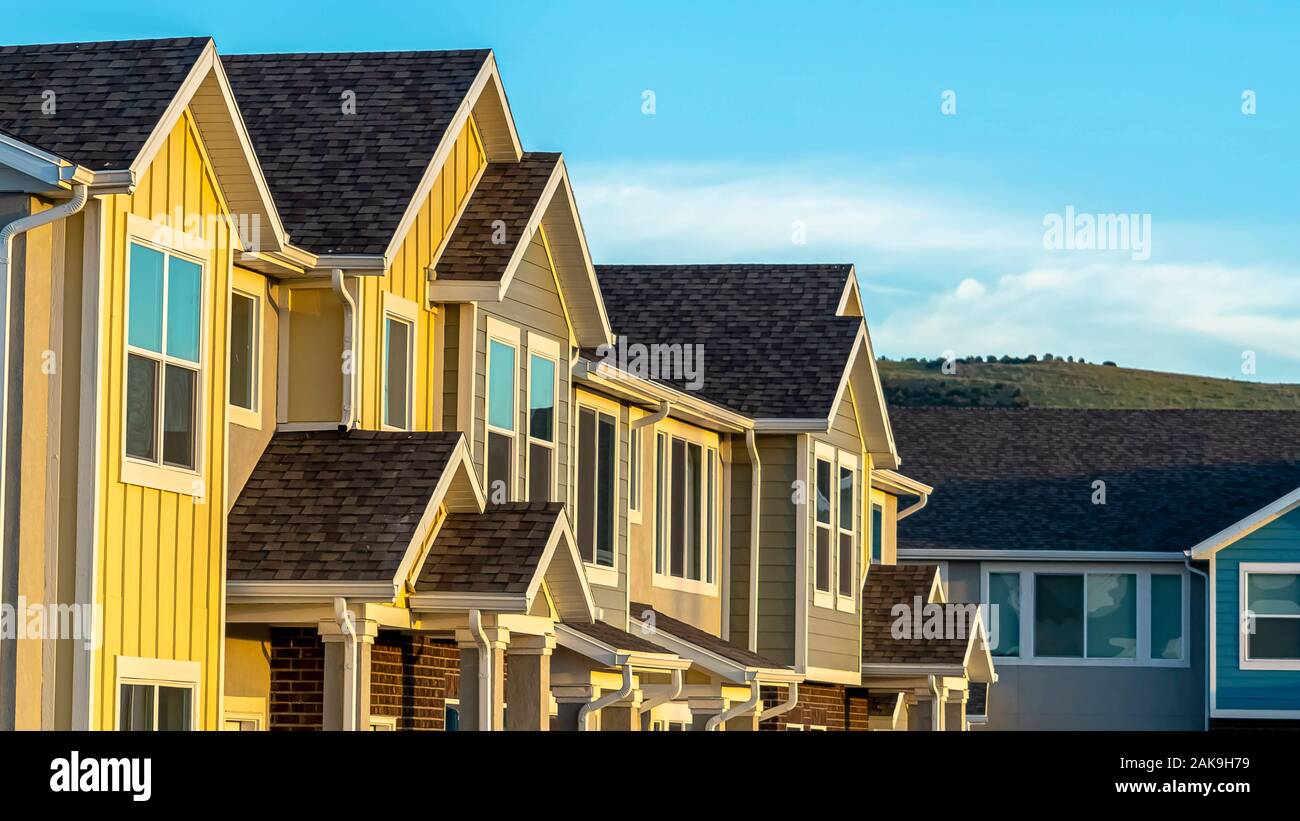 Pano frame Townhomes with wood and brick exterior wall against mountain ...