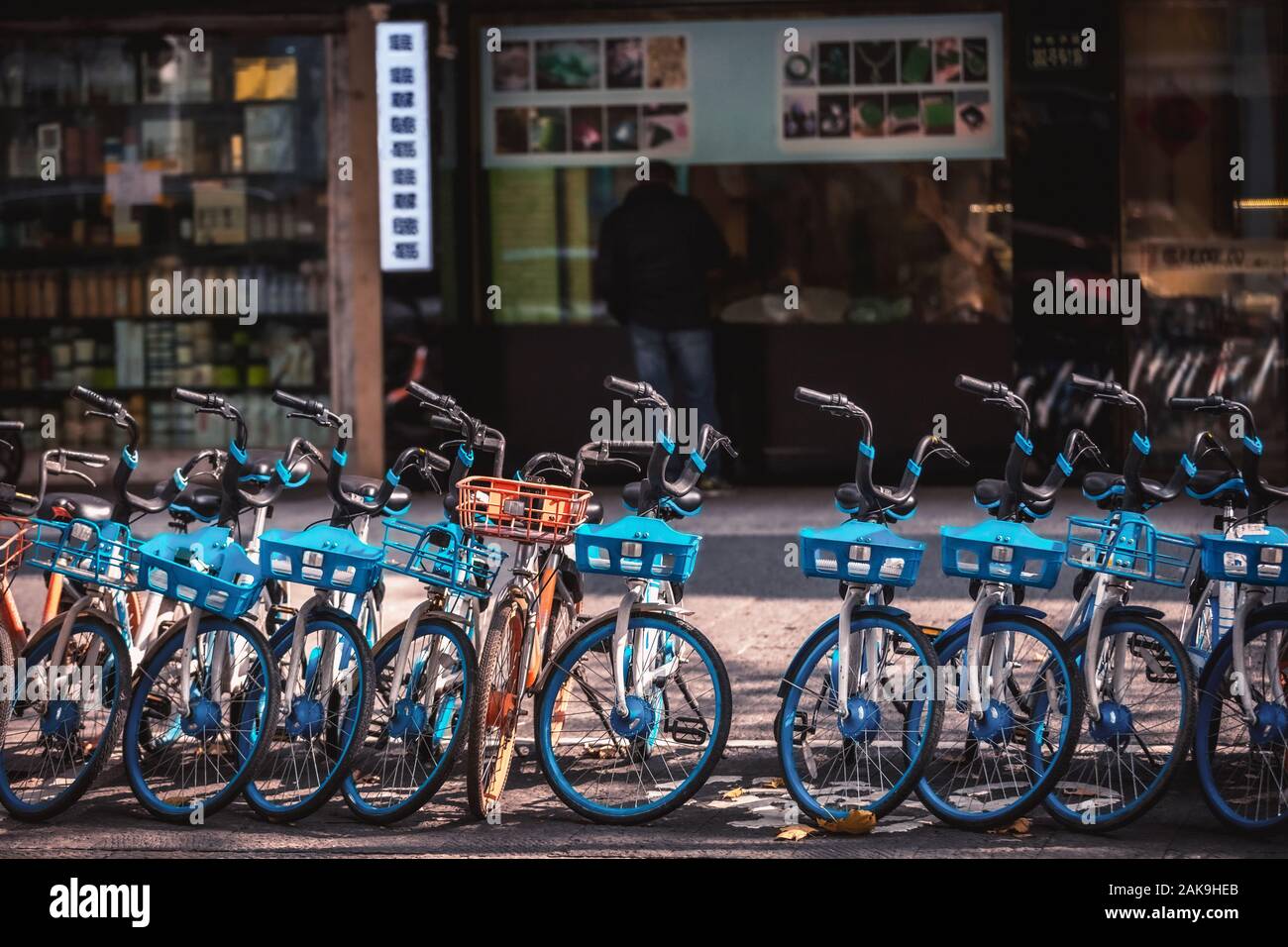 Rental electric bikes parked on the sidewalk, Hangzhou Stock Photo - Alamy