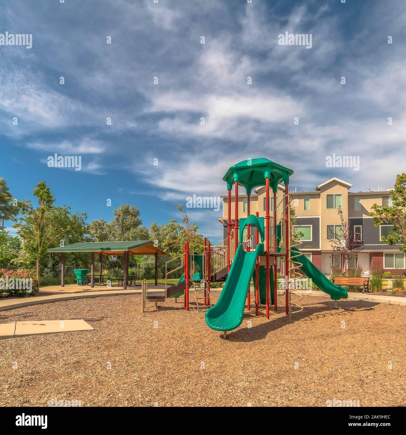 Square frame Park with playground and pavilion against townhouses and ...