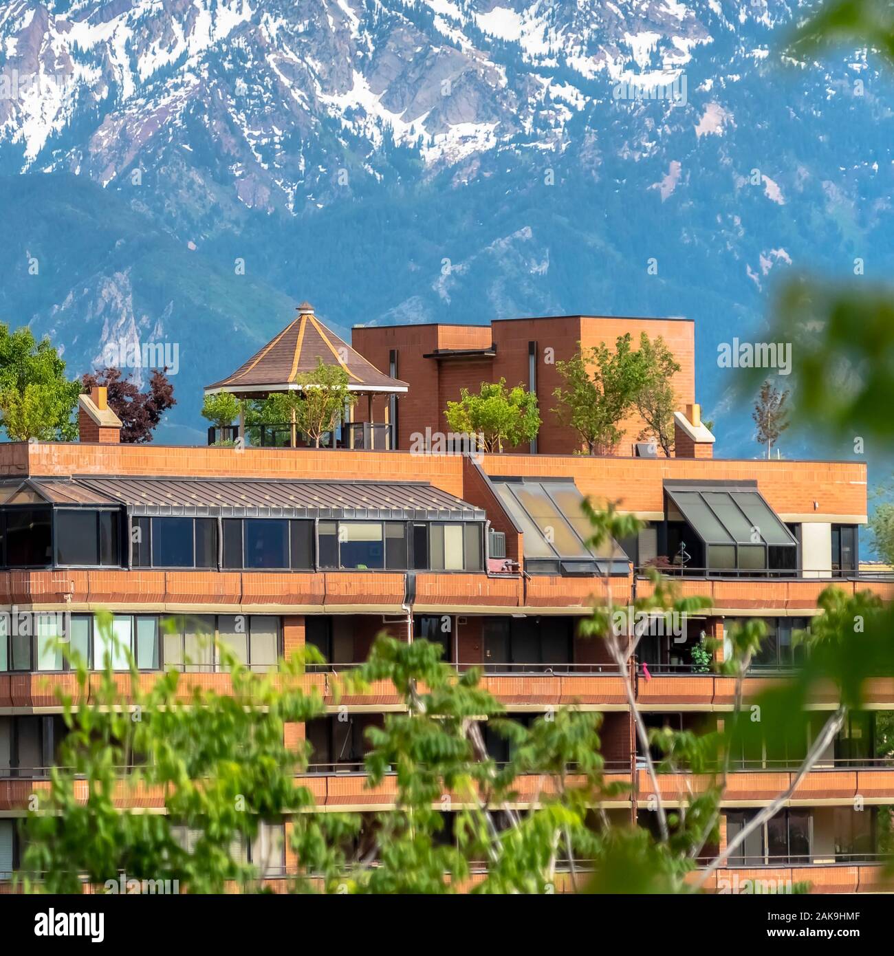 Square Red brick residential building exterior with balconies and ...