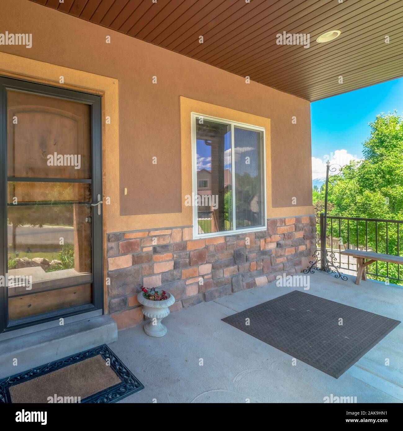Square Home exterior view with porch and glass door in front of the ...