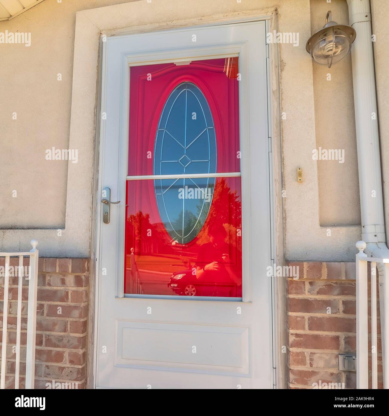 Square Exterior of a home with decorative oval glass paned vibrant red ...
