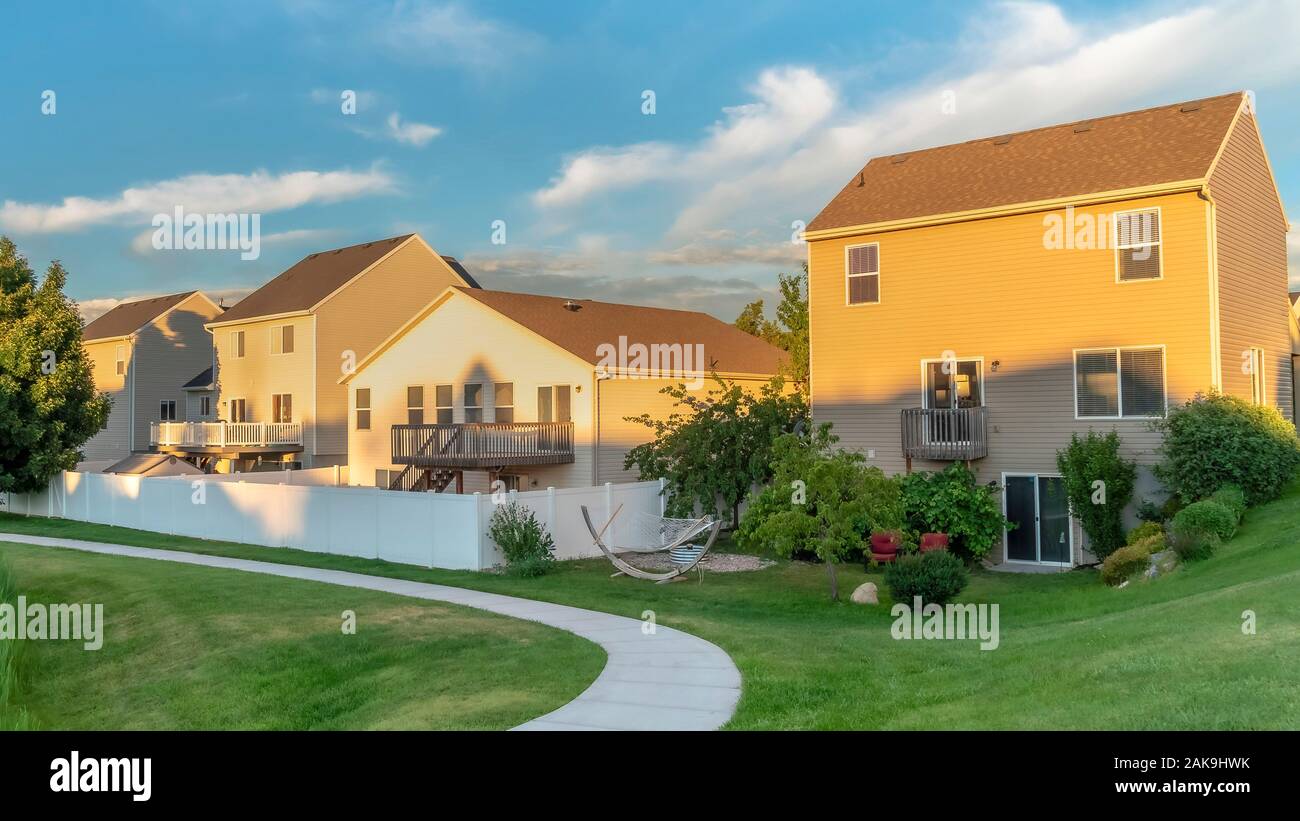 Pano frame Pathway on lush green grassy ground in front of houses with ...