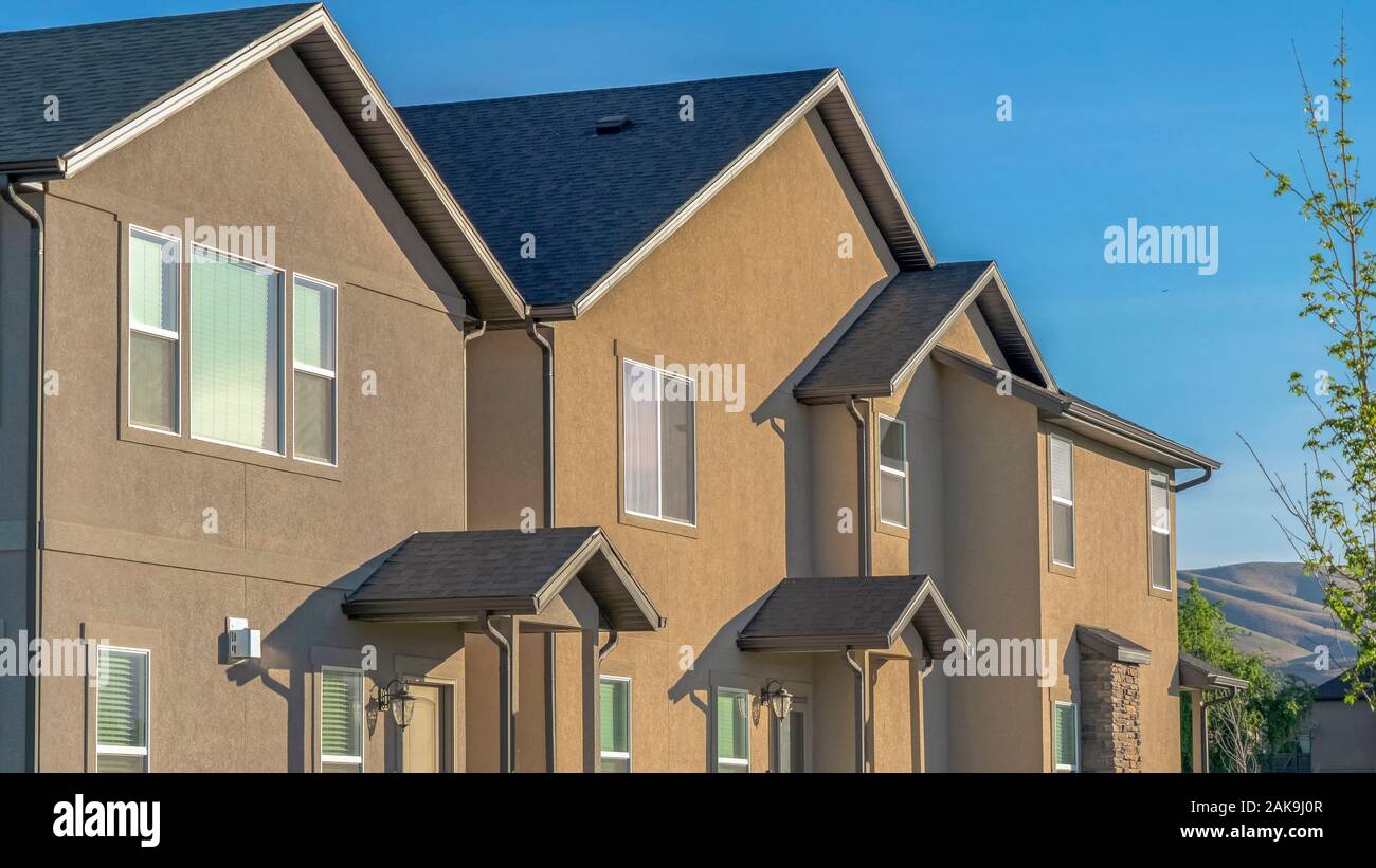 Pano frame Facade of homes with concrete and brick wall and porticos at ...