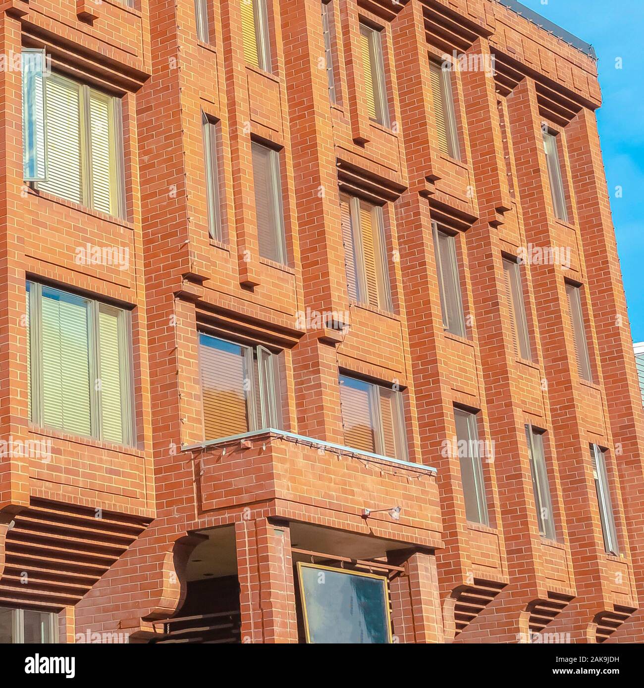 Square Exterior of a multi storey building with red brick walls and ...