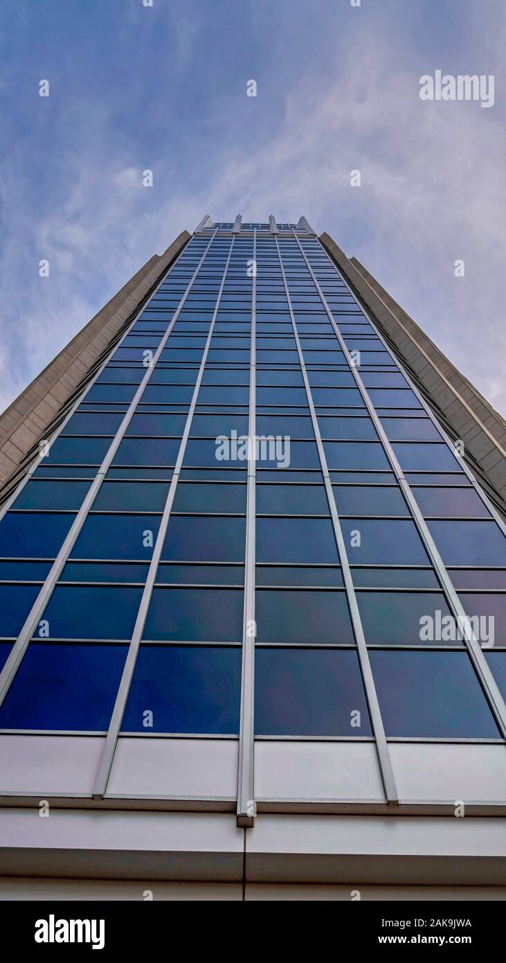 Vertical Modern building exterior viewed from below against white ...
