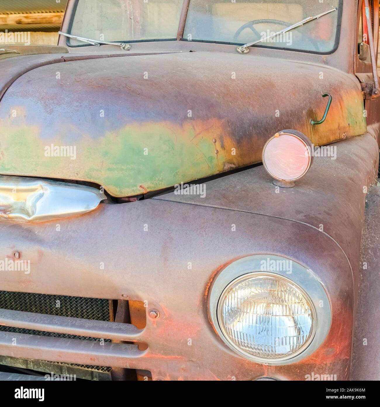 Square Front view close up of an old vintage corroded car with rusty ...