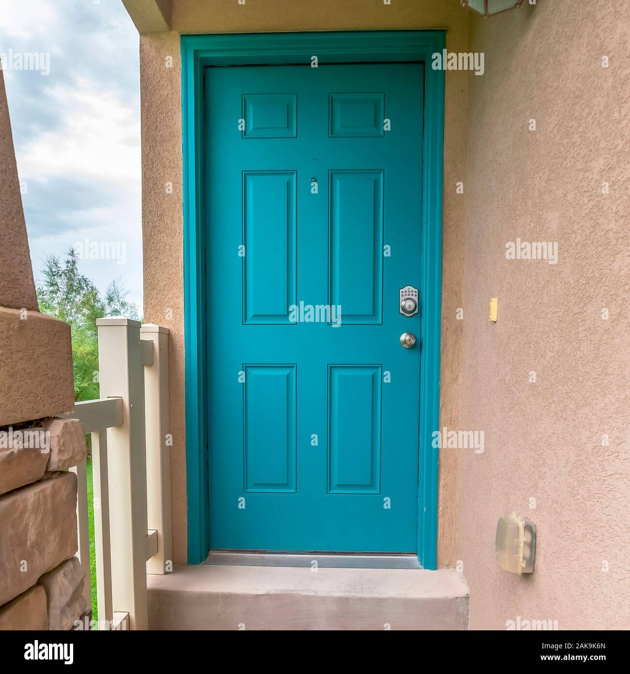 Square Close up of home entrance with blue green front door and ...