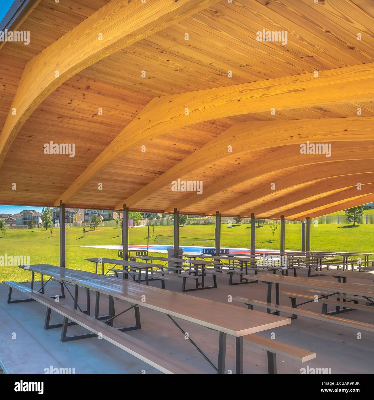 Square frame Park pavilion with white tables and seats under the brown ...