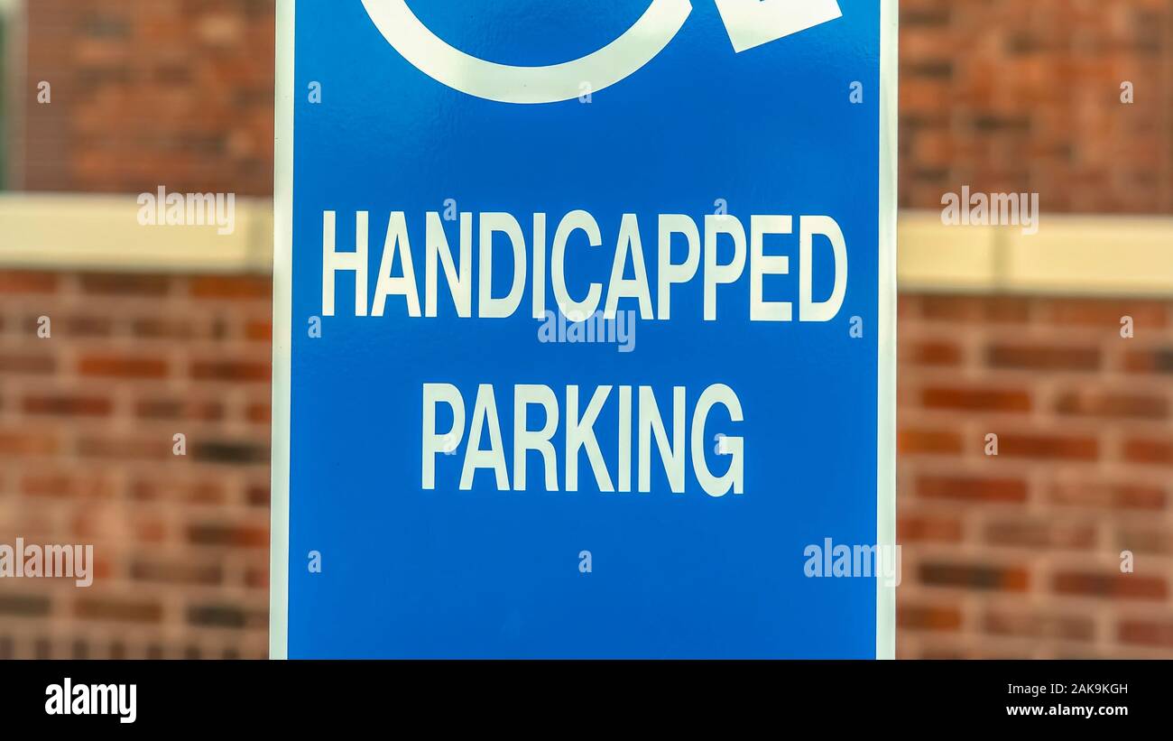 Pano Close up of Handicapped Parking sign against blurred red brick ...