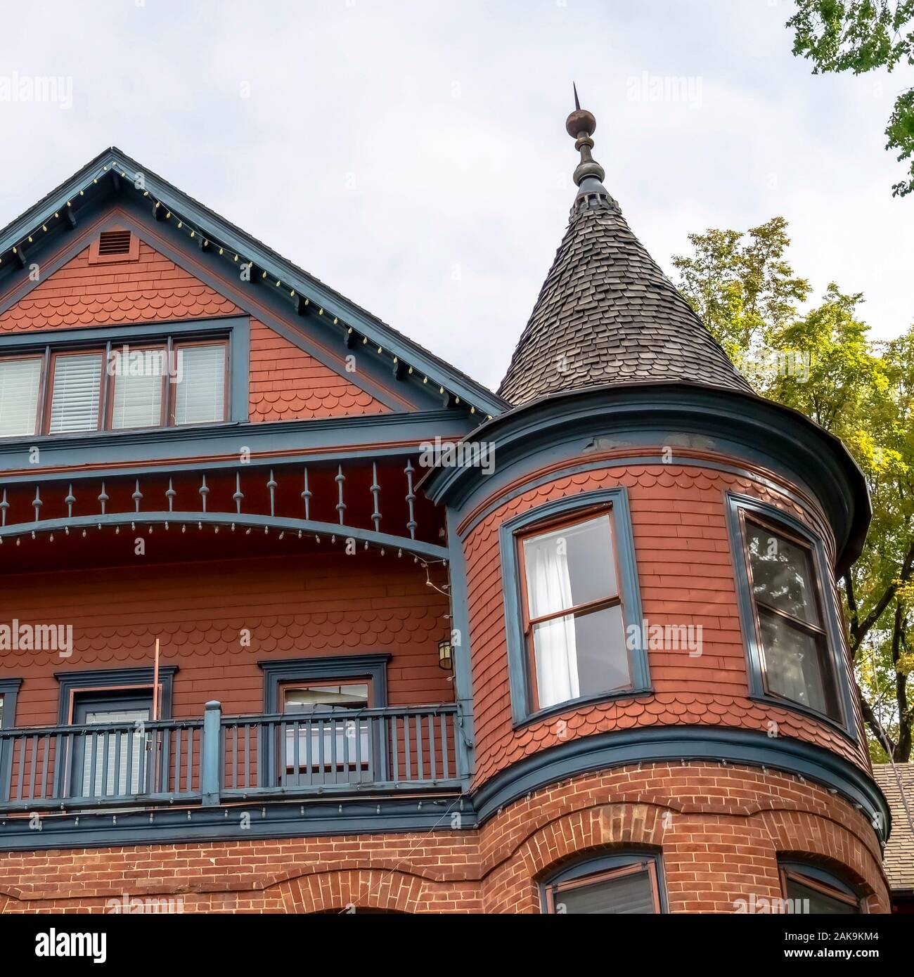 Square Exterior of a building with tower and balcony against cloudy sky ...