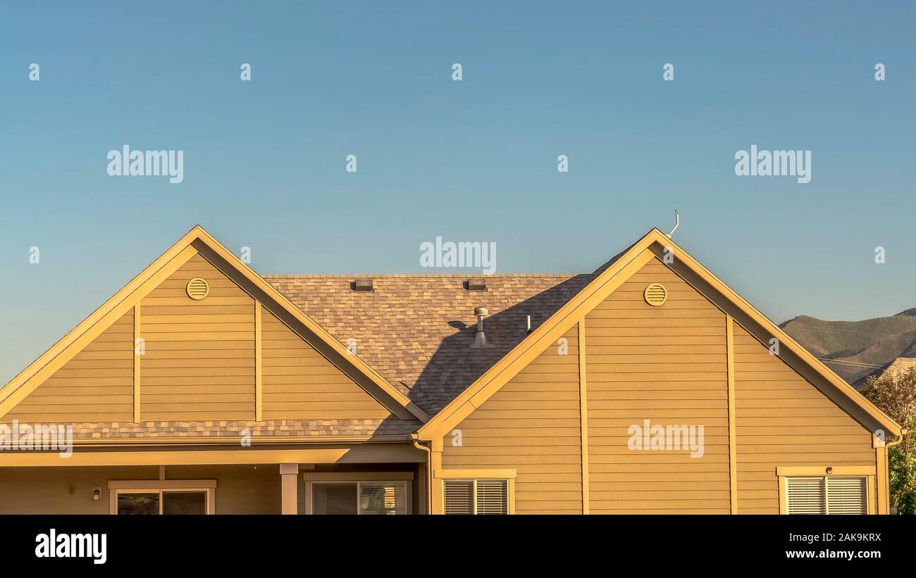 Pano frame House exterior with close up of roof against mountain and ...