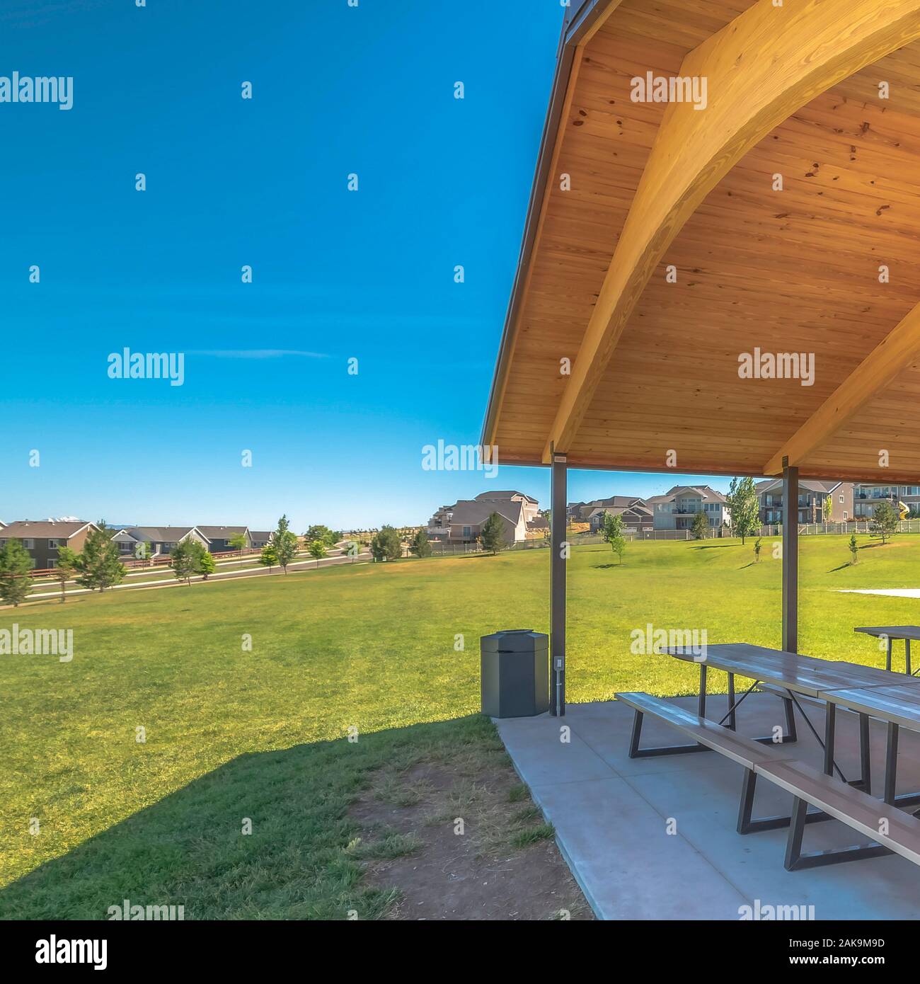 Square Park pavilion with white tables and seats under the brown wooden ...