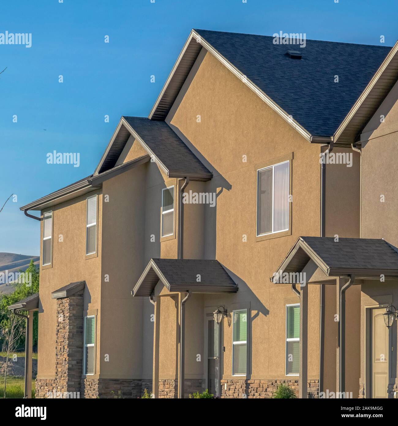 Square frame Facade of homes with concrete and brick wall and porticos ...