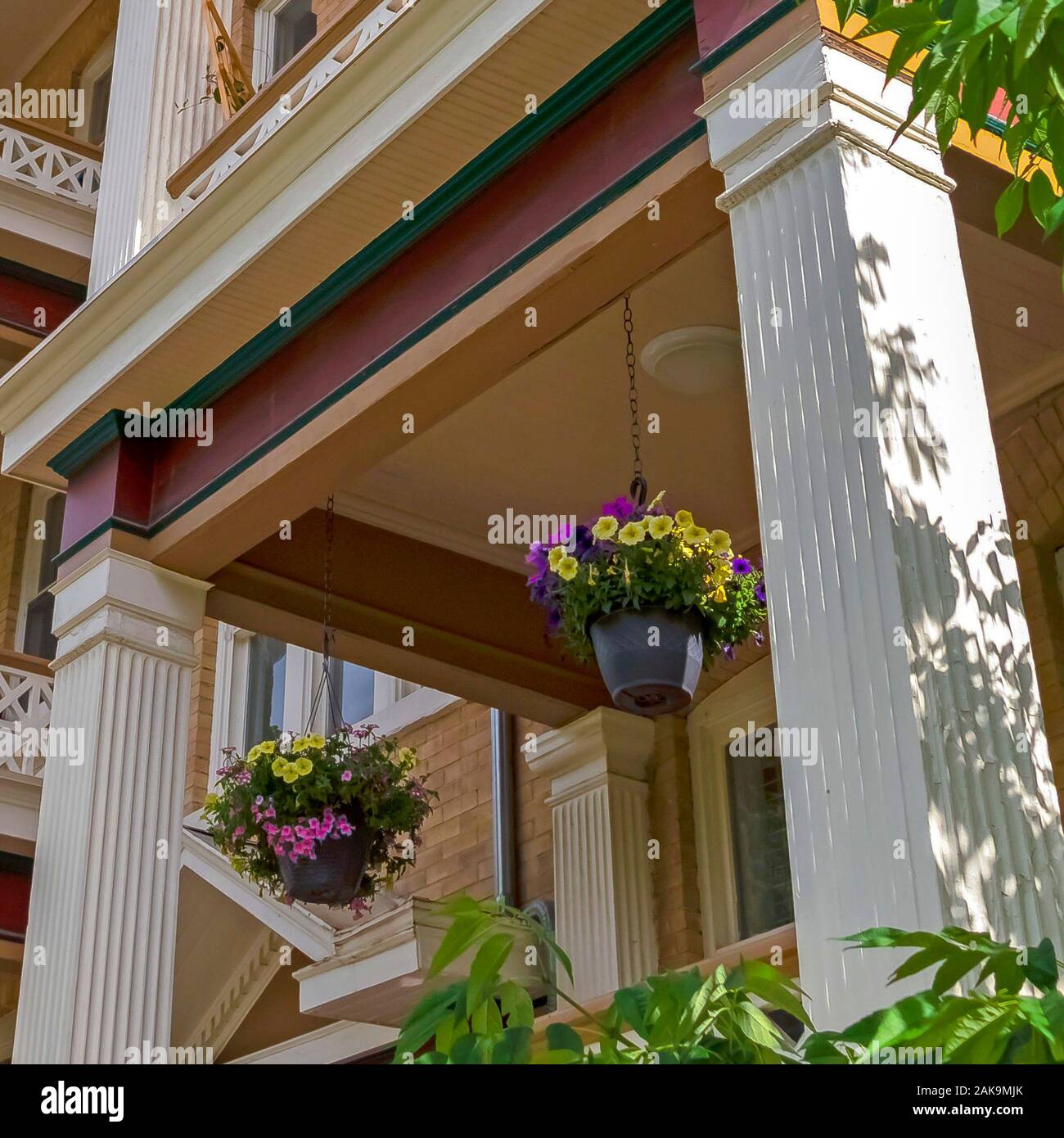 Square Townhomes balconies with columns and lattice railings against ...