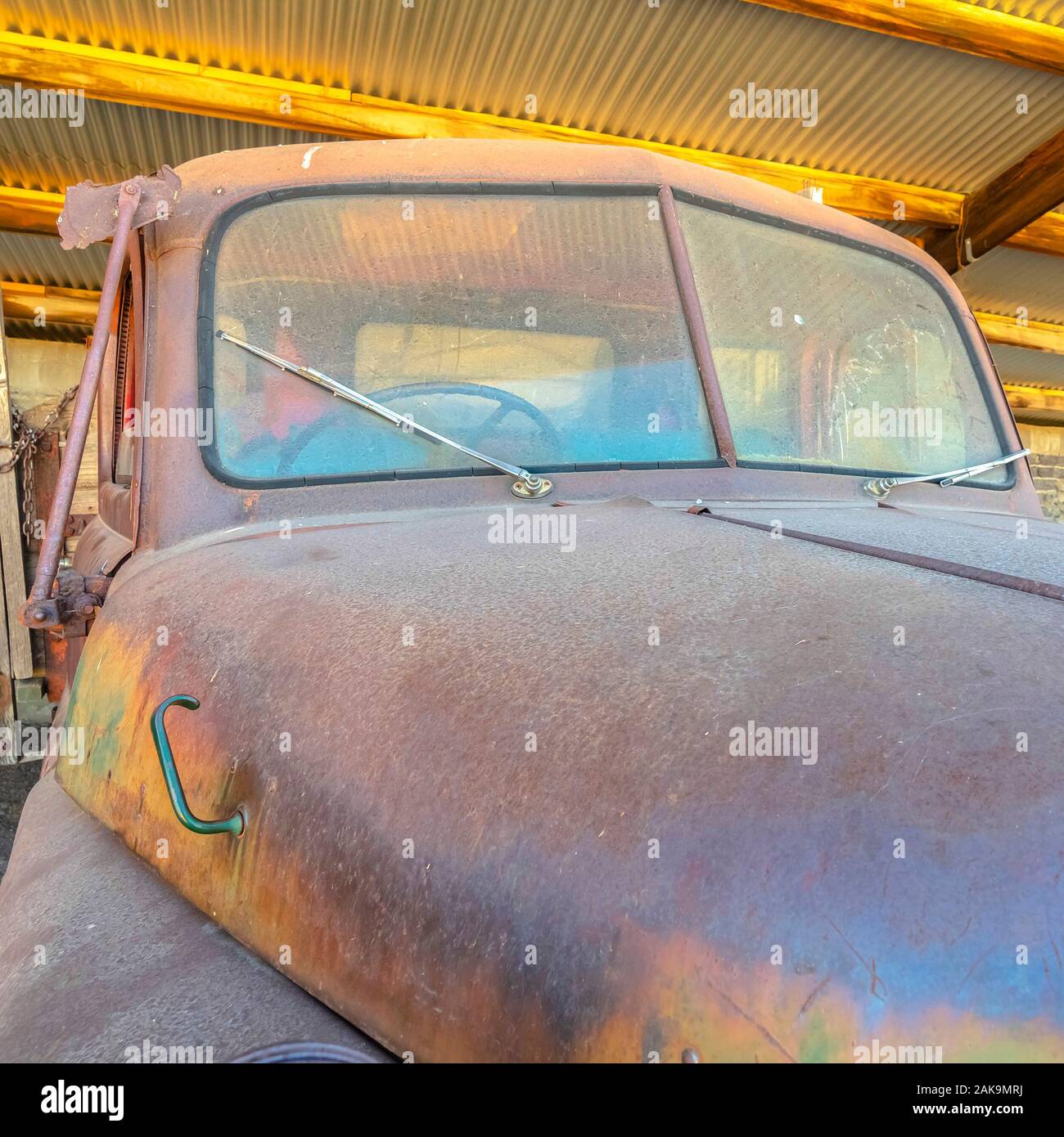 Square Old vintage car with rusty and dirty exterior inside a garage ...