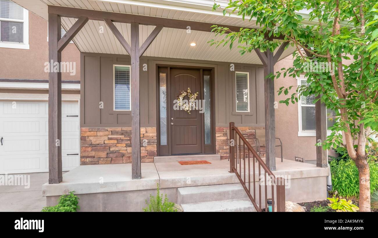 Pano frame Home with stairs leading to porch and door flanked with ...