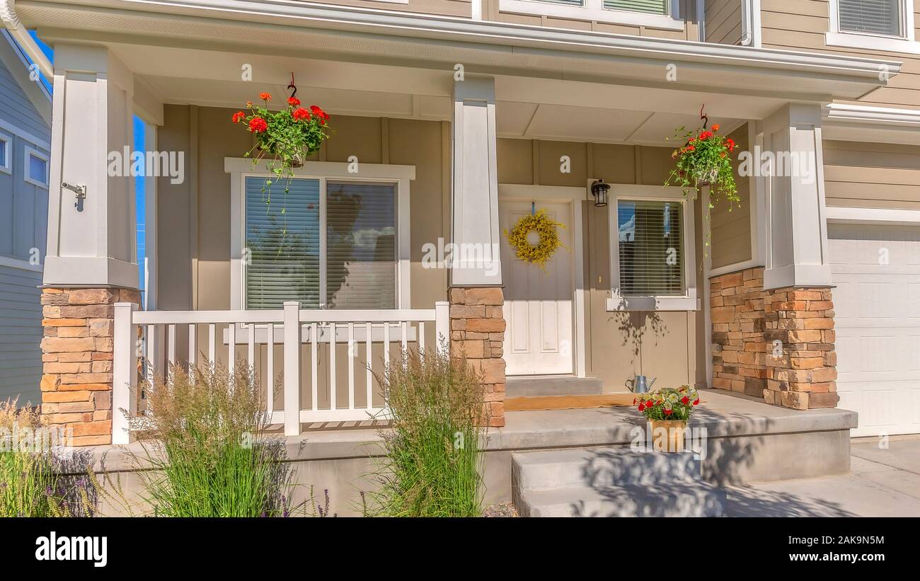 Pano Exterior of sunlit home with pathway and stairs leading to porch ...