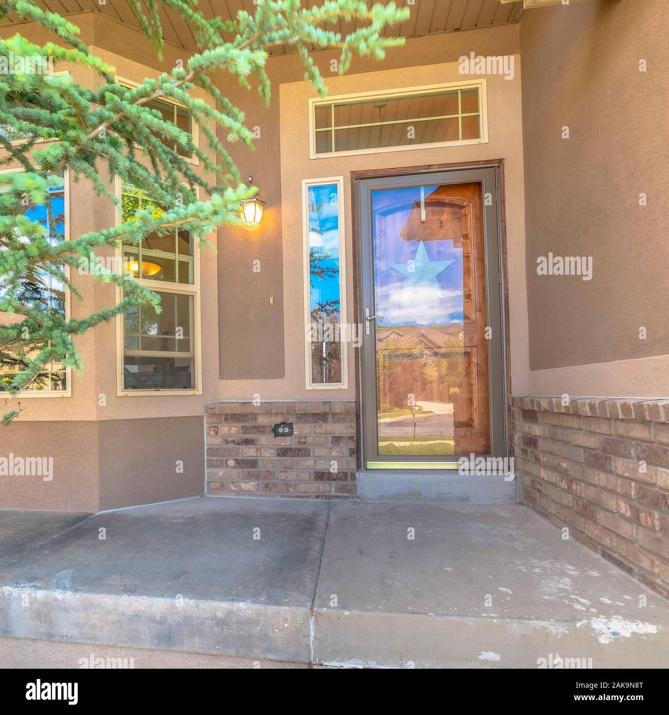 Square Home with bay window and glass paned door with sidelight and ...