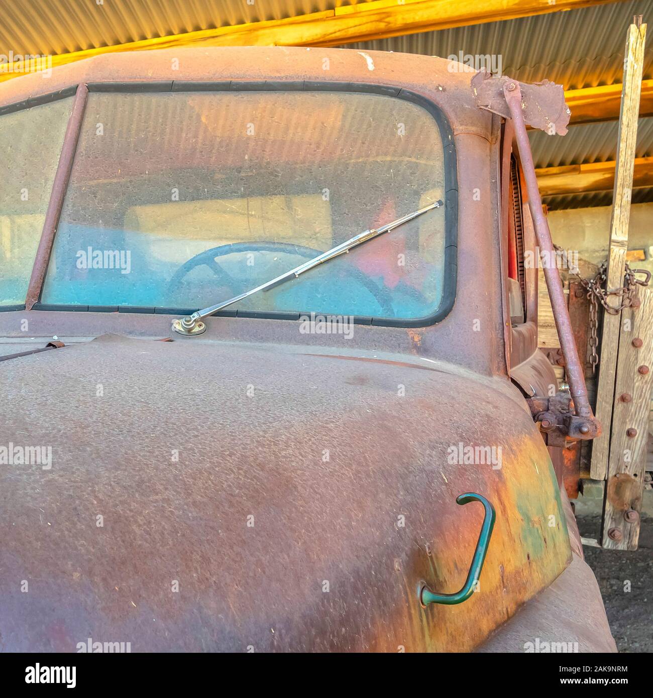Square frame Old vintage car with rusty and dirty exterior inside a ...