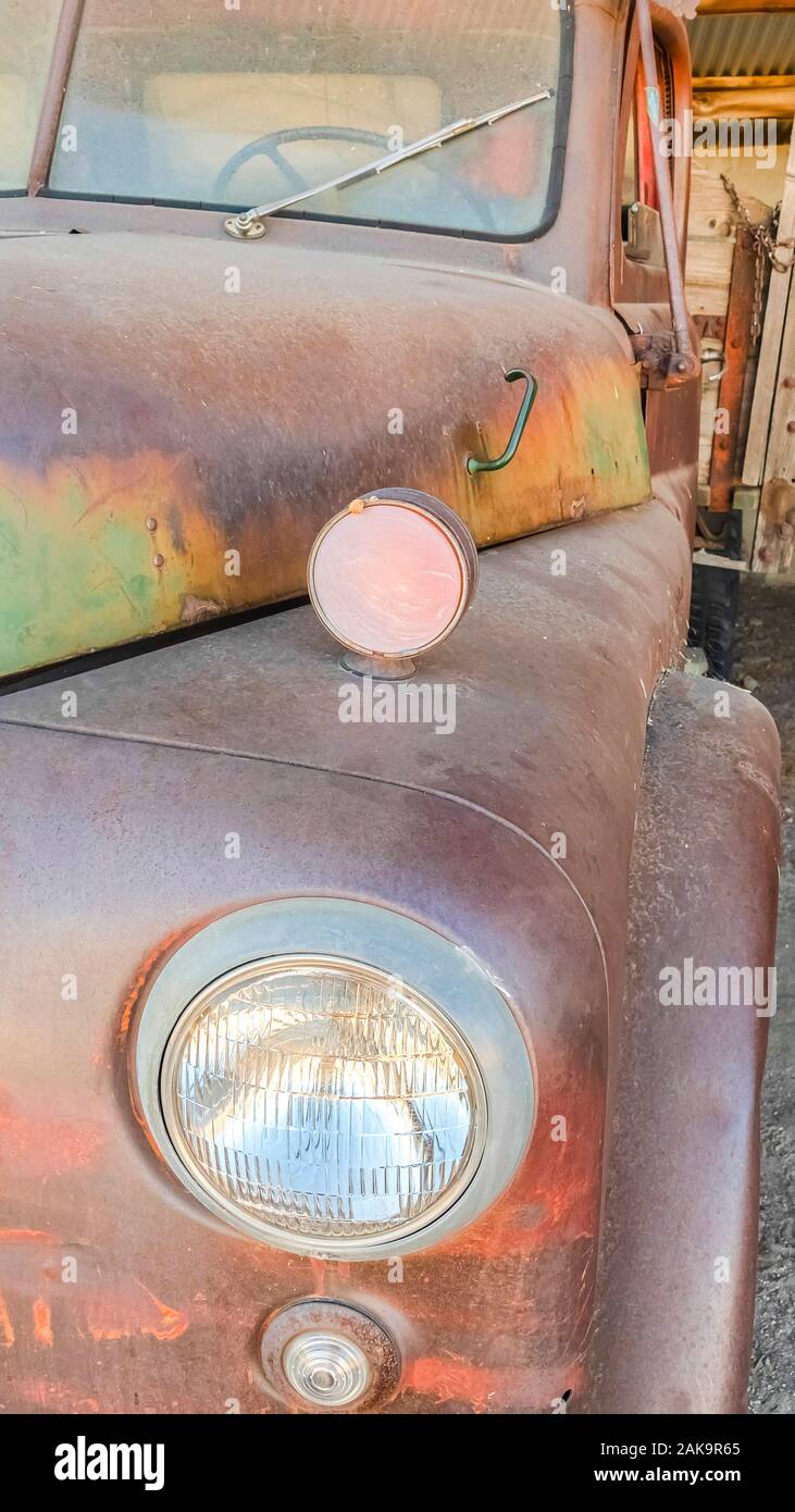 Vertical Front view close up of an old vintage corroded car with rusty ...