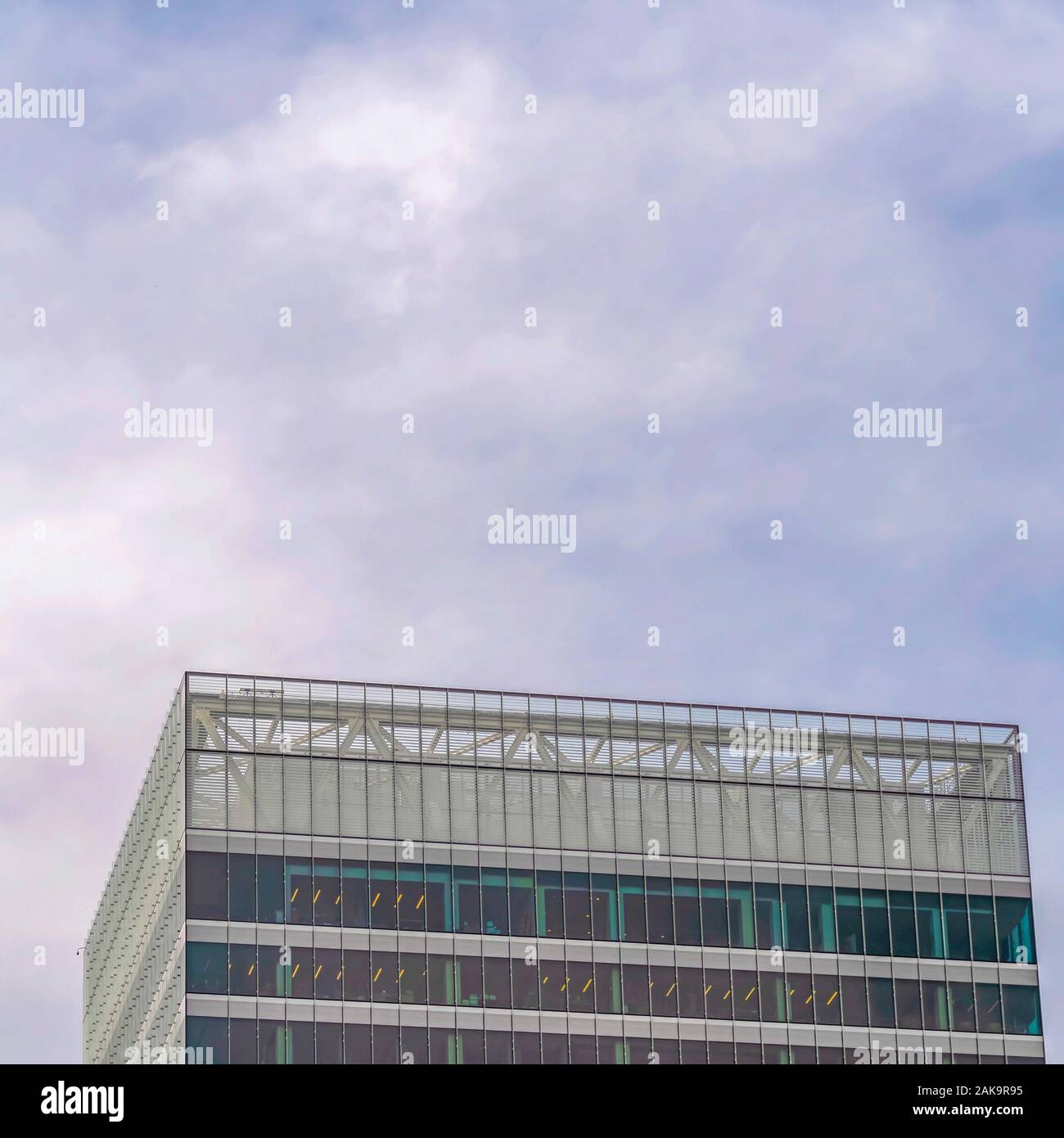 Square Modern commercial building exterior with tall glass windows ...