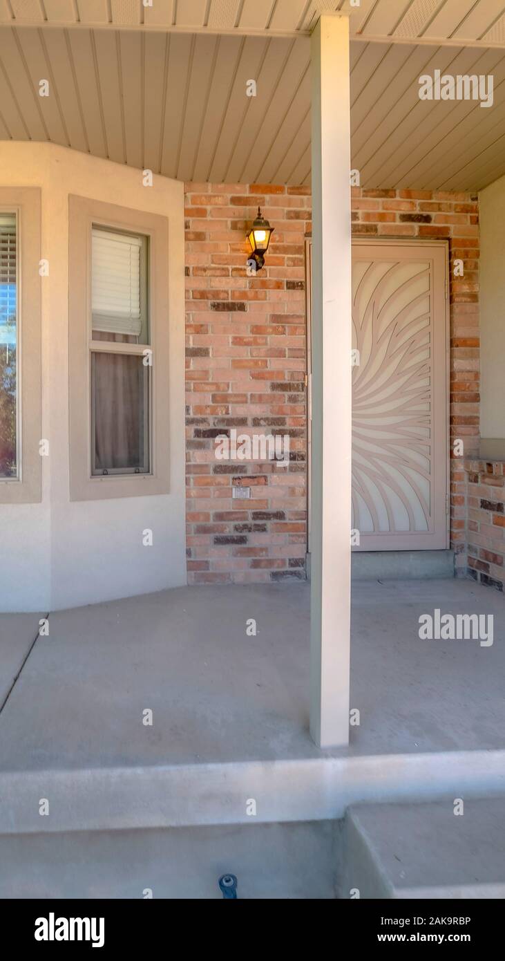 Vertical frame Home facade with bay window and front porch supported by ...