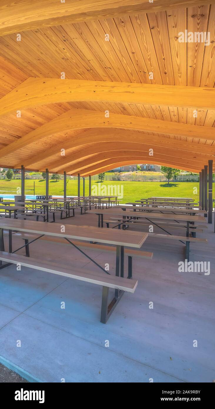 Vertical frame Sunny day views at a park with pavilion and basketball ...