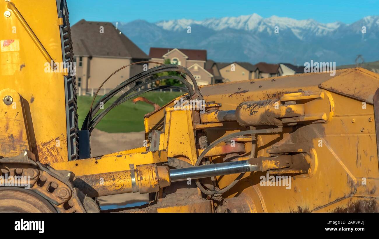 Pano frame Yellow bulldozer with close up view of the mechanism at the ...
