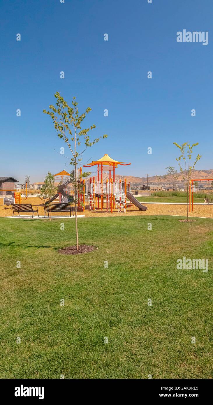 Vertical frame Scenic park with picnic tables and benches and ...