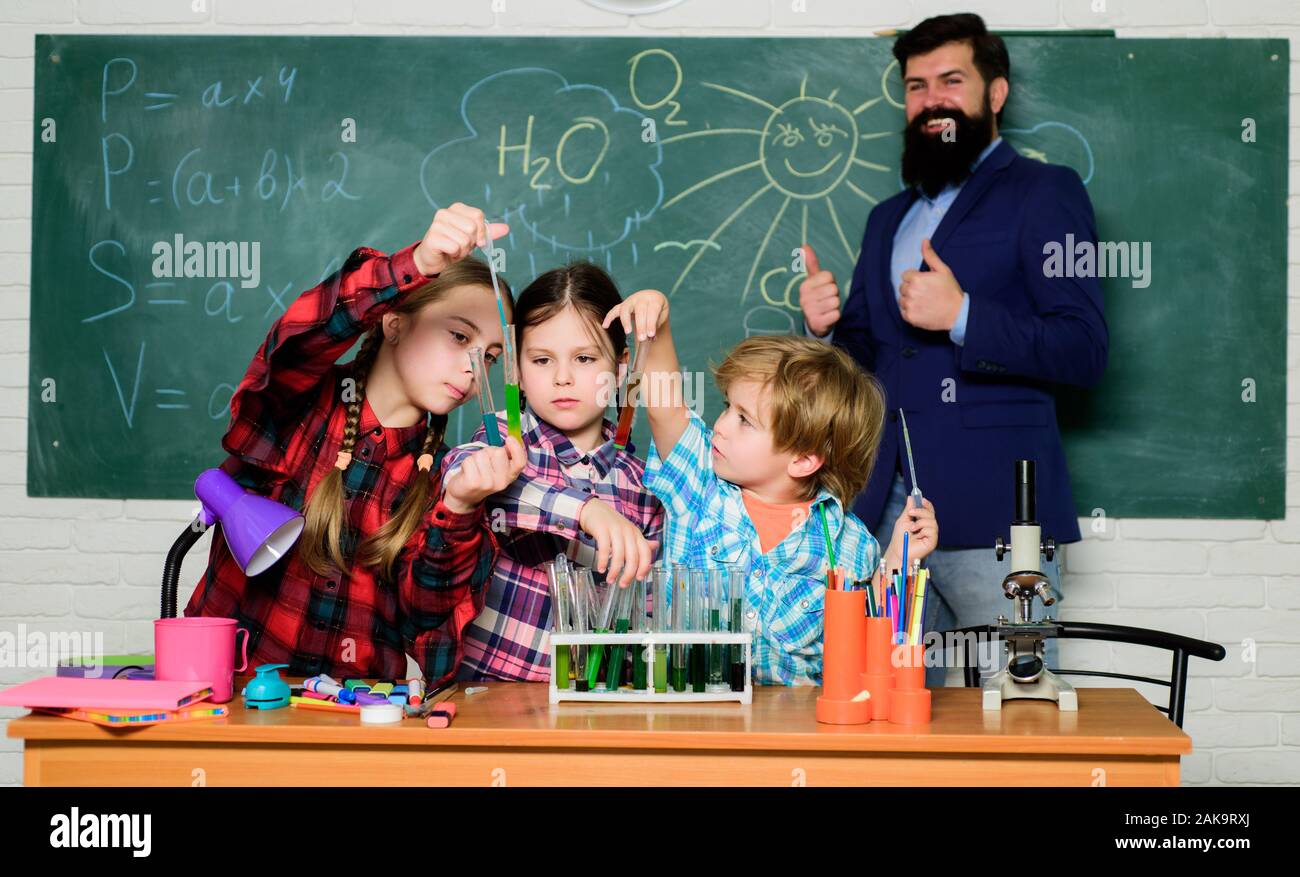 back to school. kids in lab coat learning chemistry in school ...