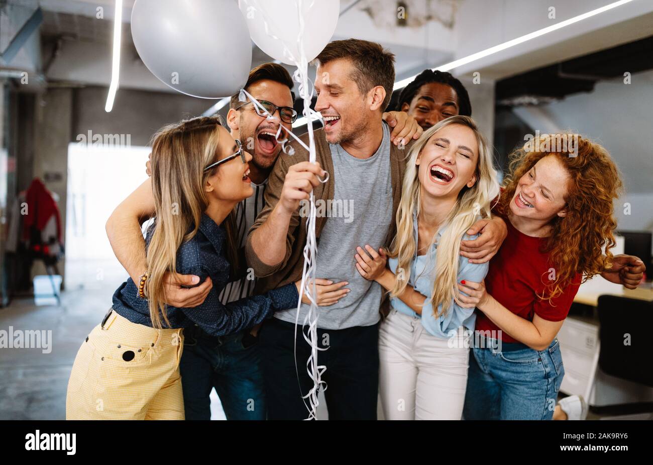 Happy business people celebrating success at company Stock Photo - Alamy
