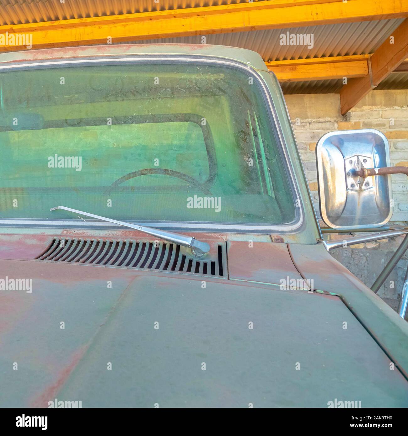 Square frame Close up front view of an old vintage car with dirty and ...