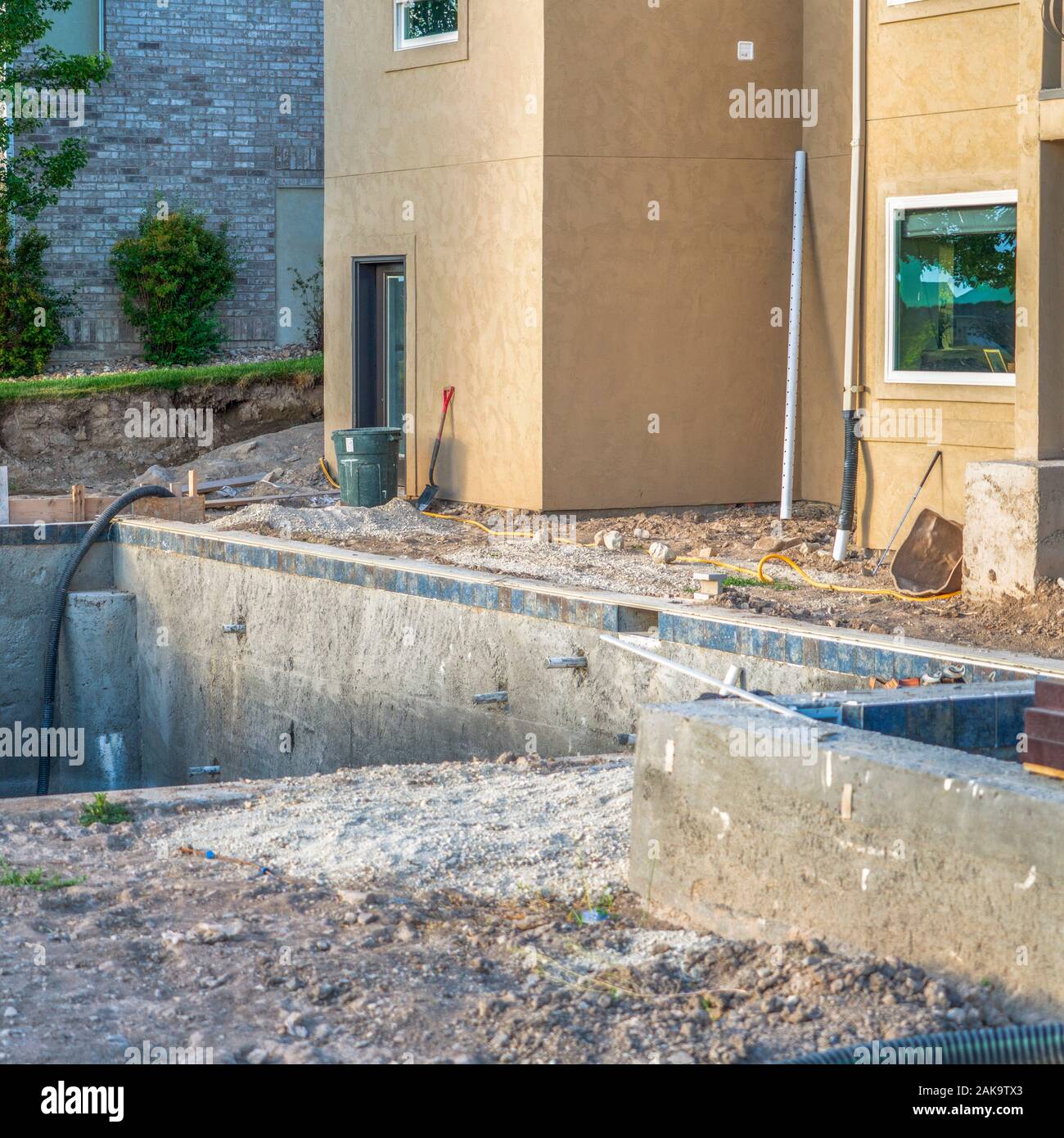 Square Construction of a residential swimming pool with houses and ...