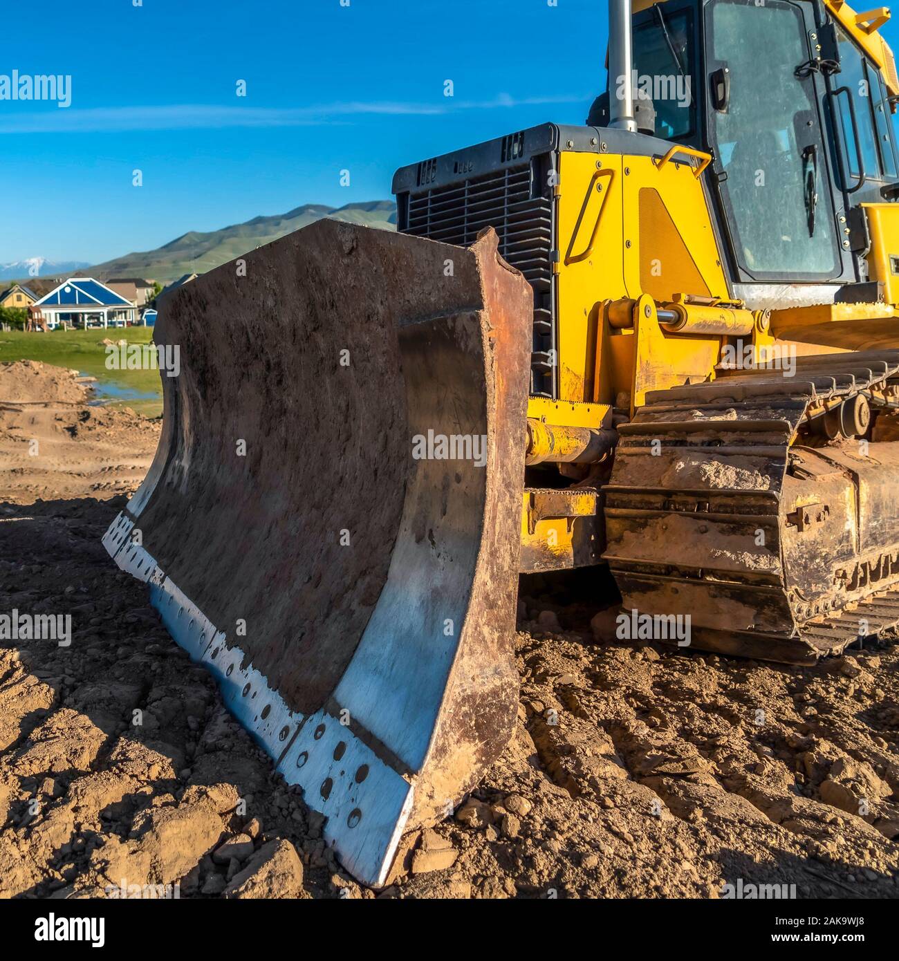 Square frame Close up of a bulldozer with metal blade yellow paint and ...