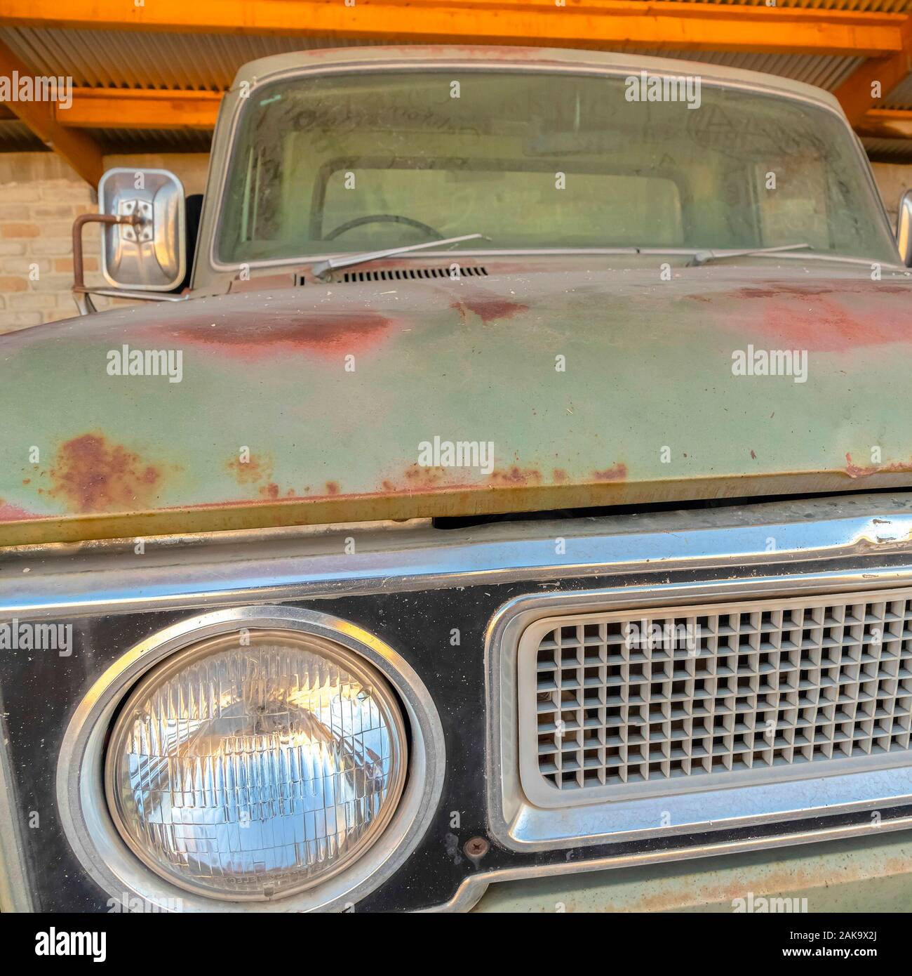 Square Front view of the dirty and rusty exterior of an old vintage ...