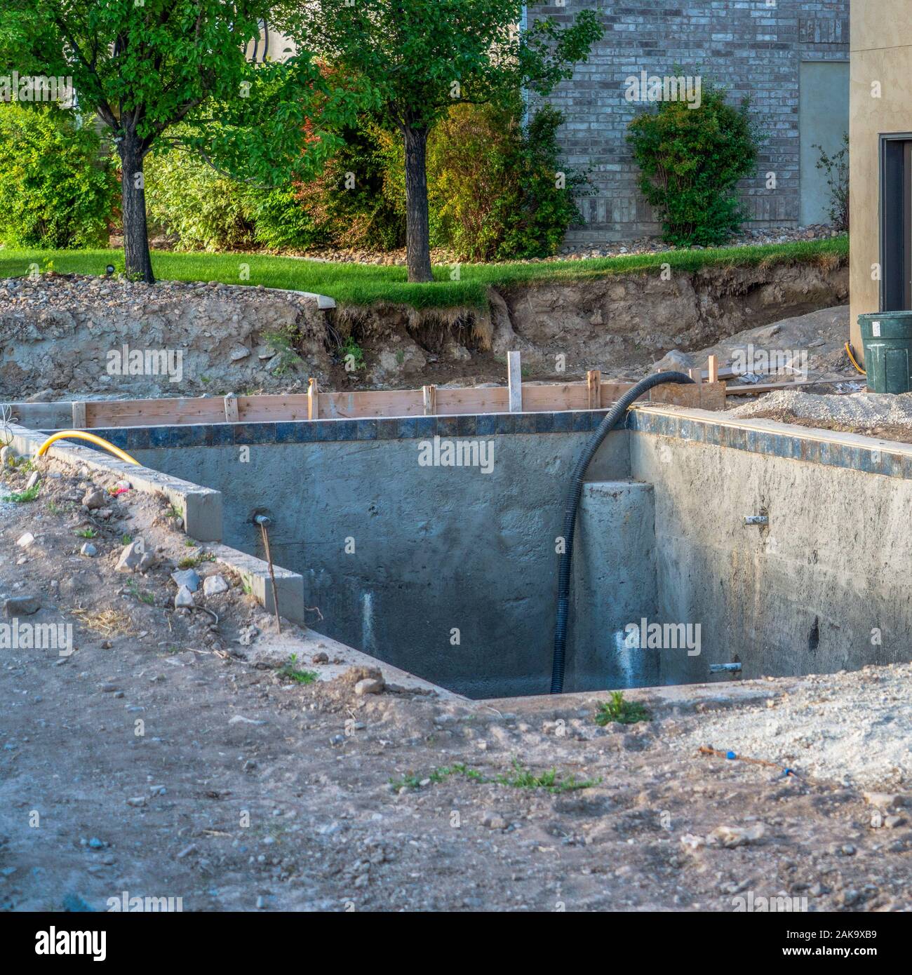 Square frame Construction of a residential swimming pool with houses ...