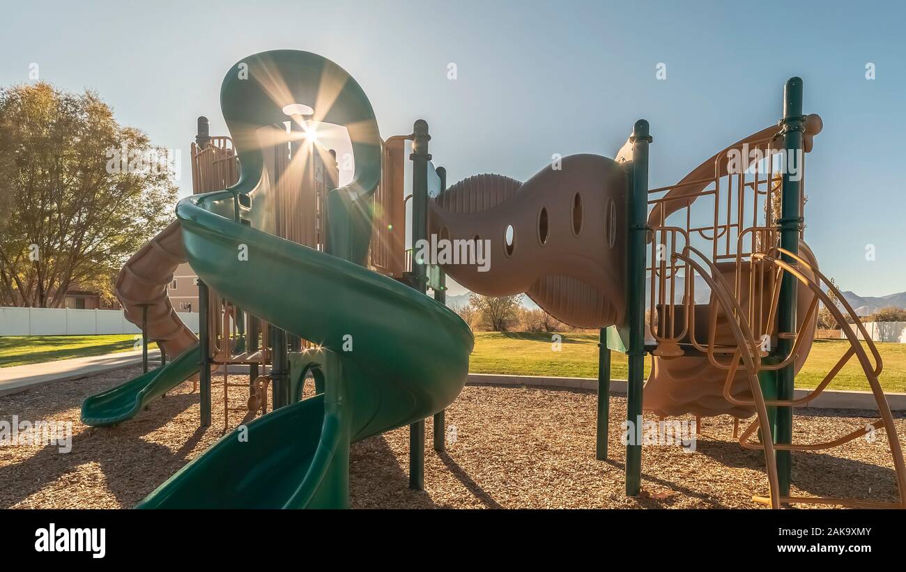 Panorama frame Sunburst through equipment on a kids playground Stock ...