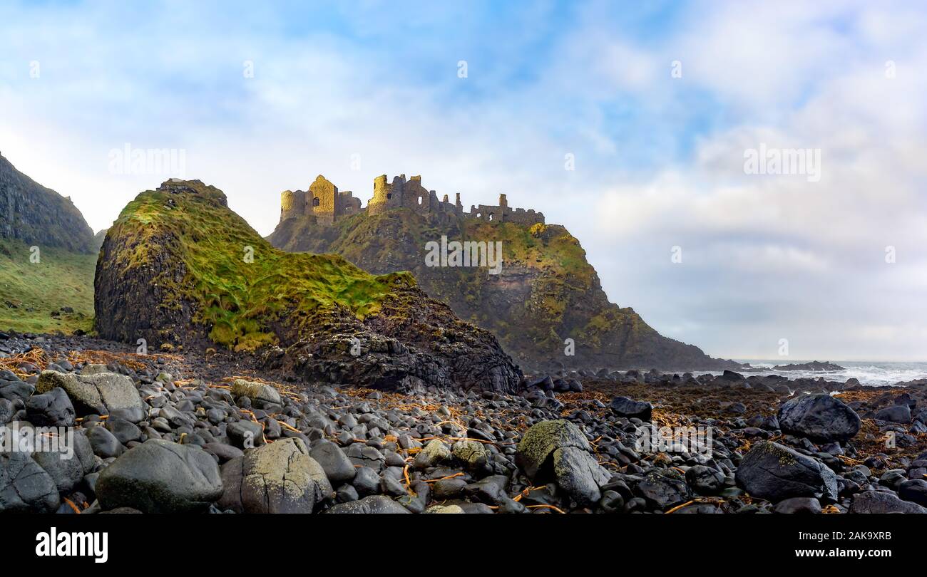 Ruined medieval Dunluce Castle on the cliff in Bushmills town. Filming ...
