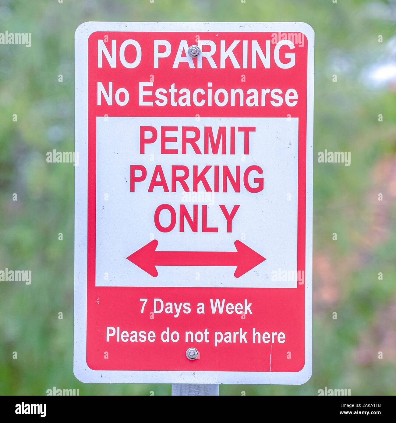 Square frame Red No Parking warning sign duplicated in Spanish Stock ...