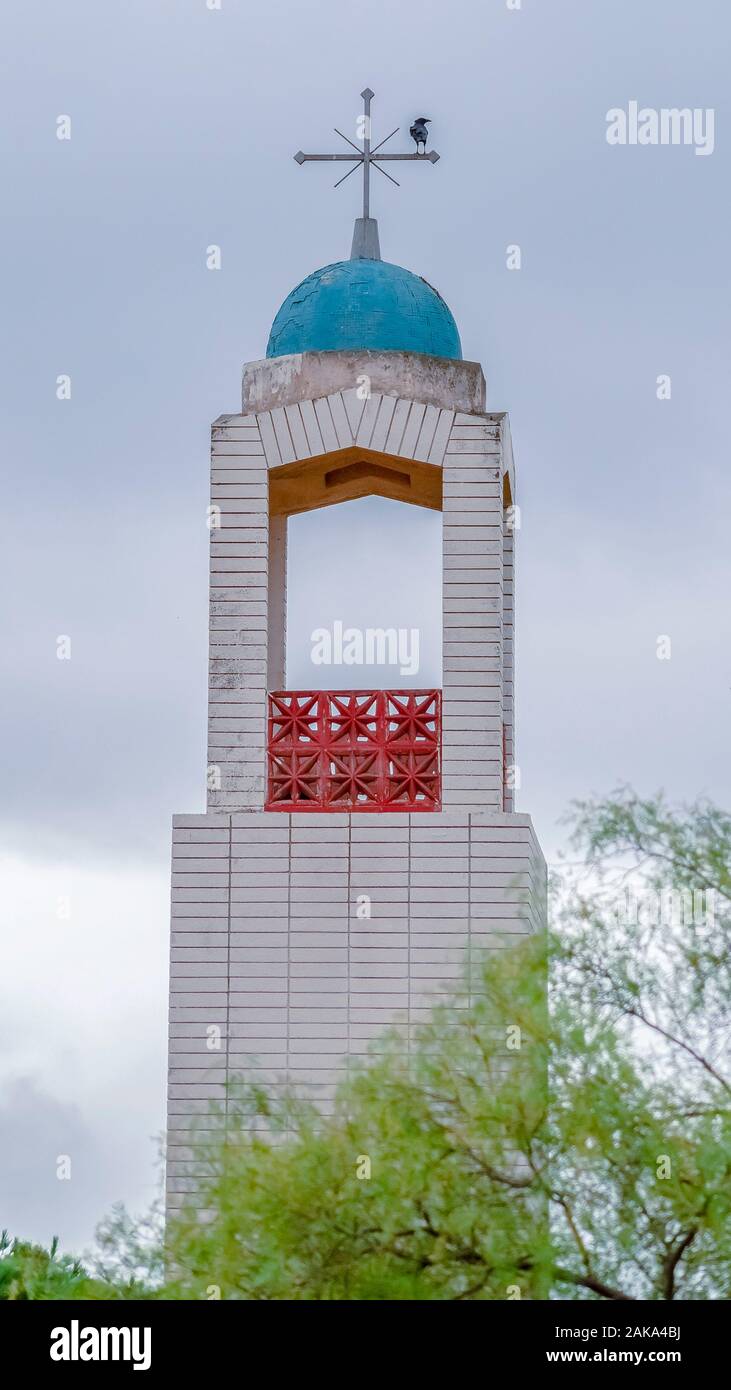 Vertical frame Bell tower of a small church above trees Stock Photo - Alamy