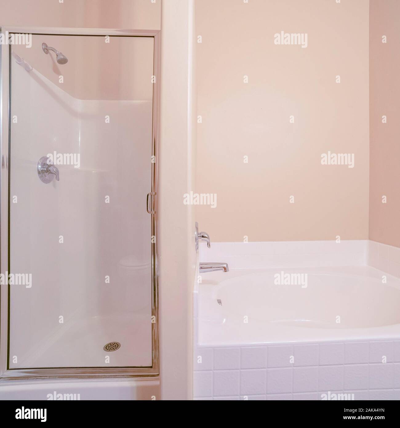 Square frame Shower cabin and bathtub in bathroom in home Stock Photo ...