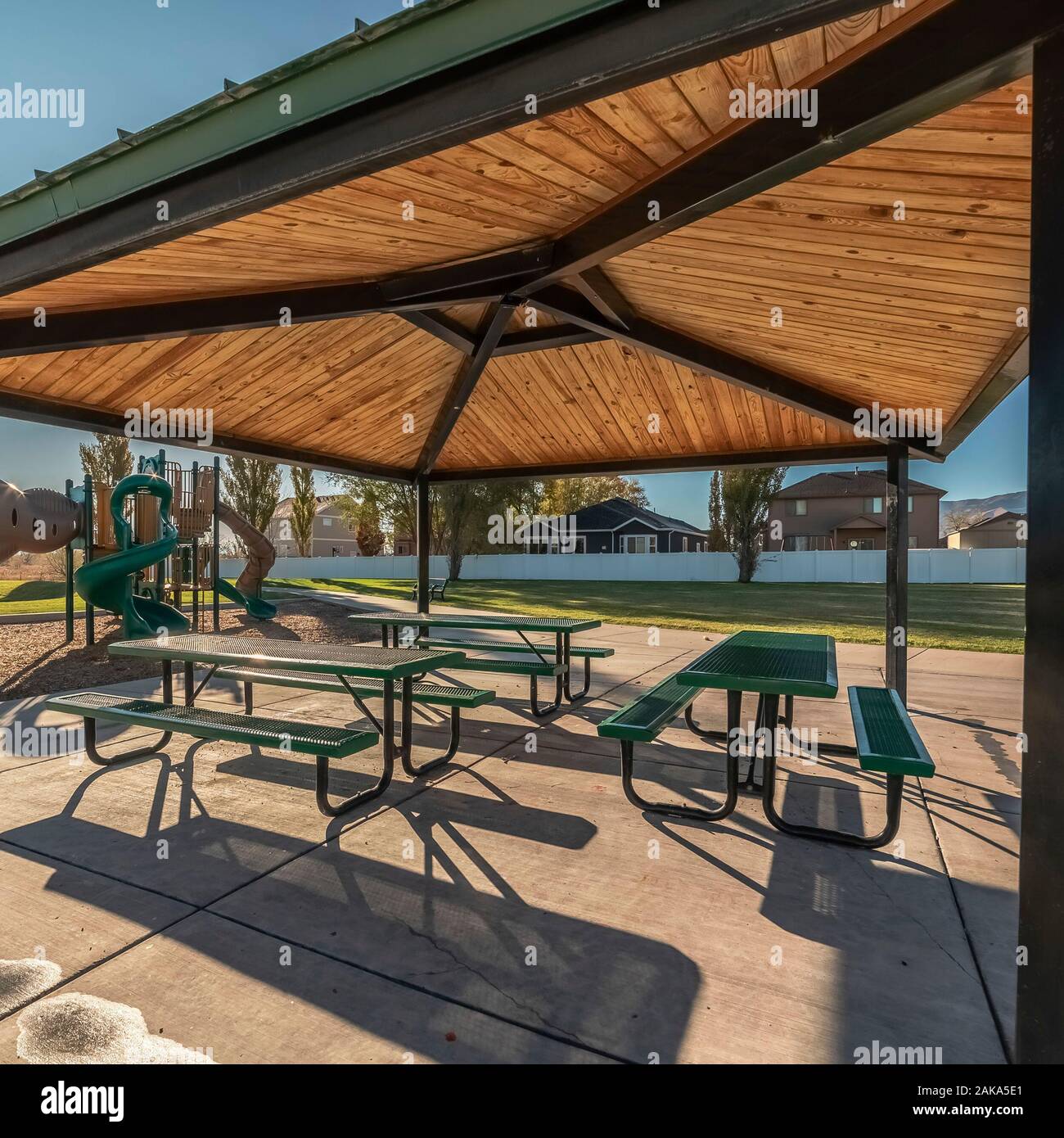 Square Green benches and tables in an urban park Stock Photo - Alamy