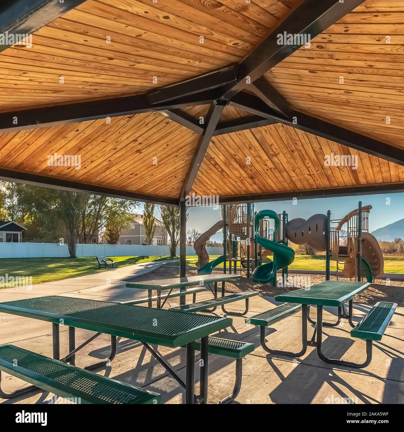 Square Covered picnic tables in a small urban park Stock Photo - Alamy