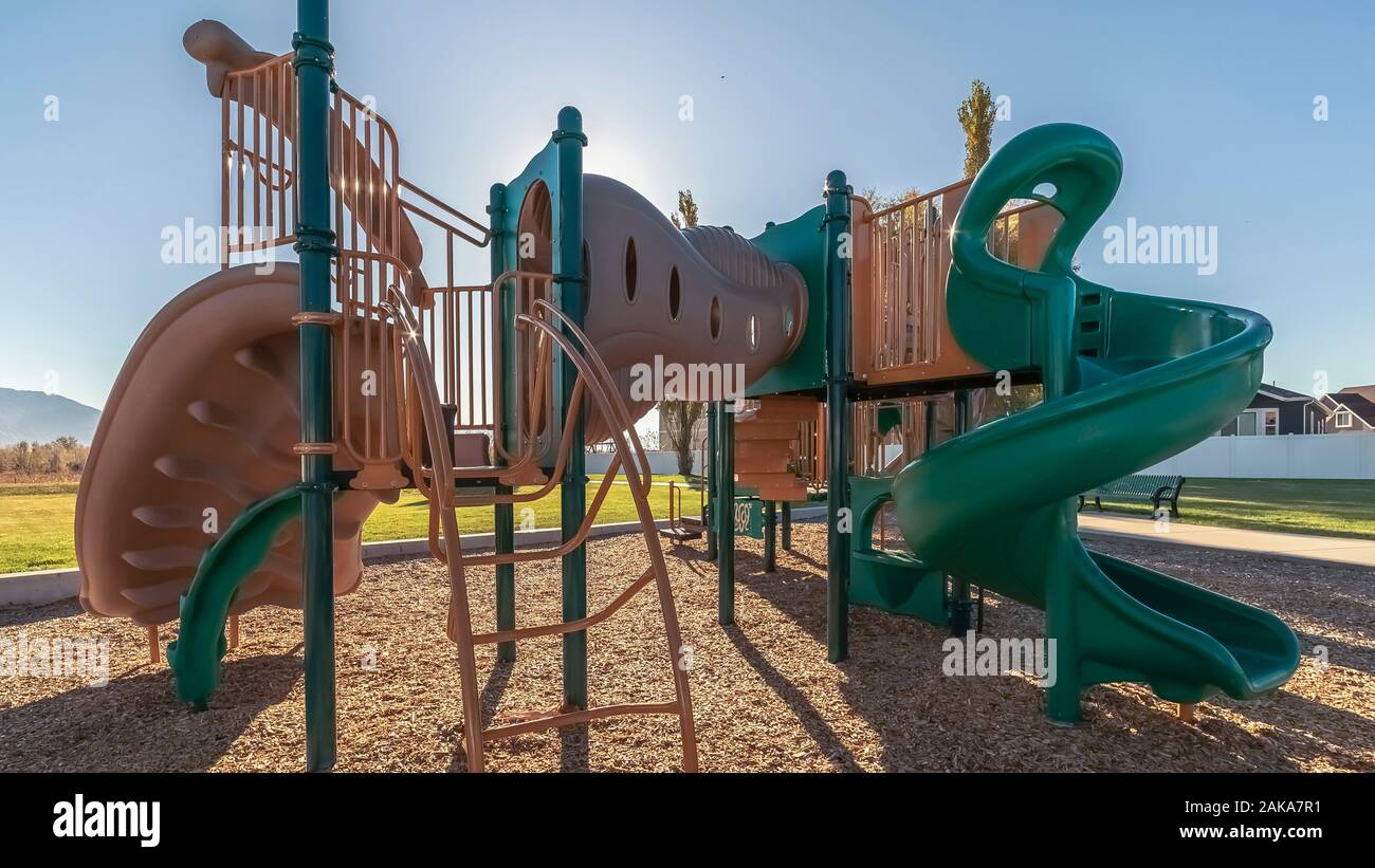 Panorama Colorful twisted slides in a kids playground Stock Photo - Alamy