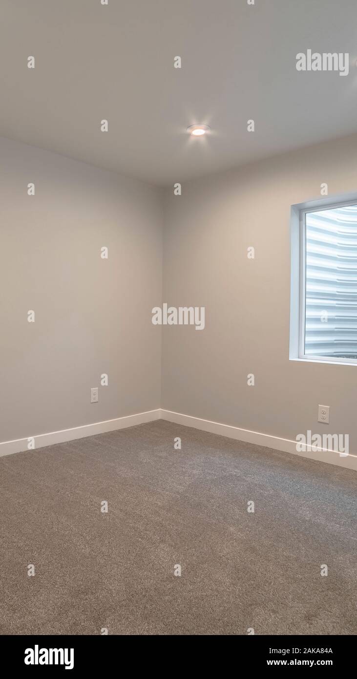 Vertical Interior of an empty small white room Stock Photo - Alamy