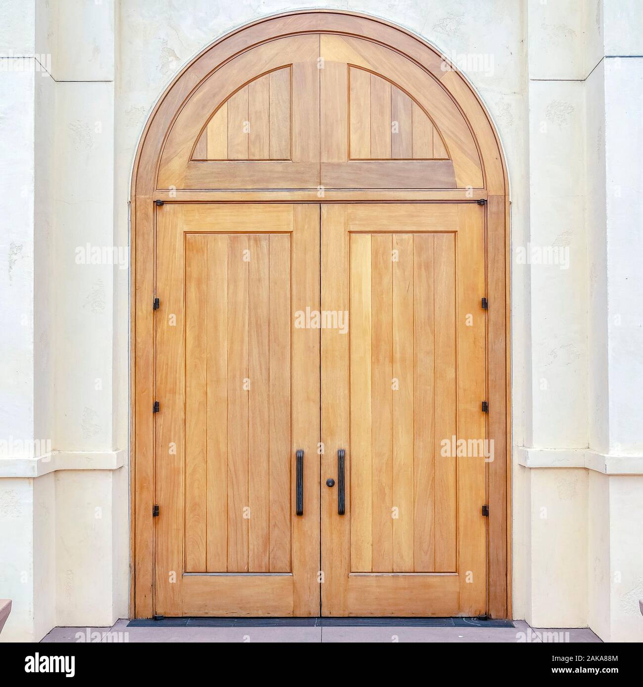 Square frame Double arched wooden entrance door of exterior Stock Photo ...