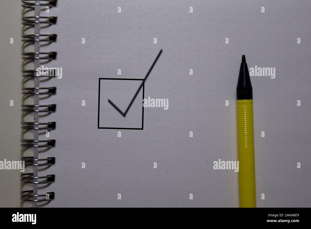 Close up the checkbox and a pen on white book Stock Photo - Alamy